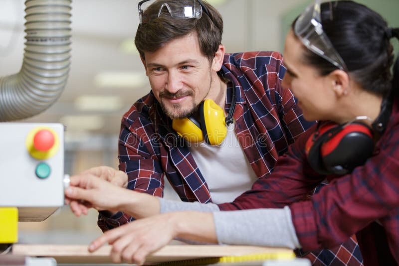 Man and Woman Checking Machine in Factory Stock Photo - Image of ...