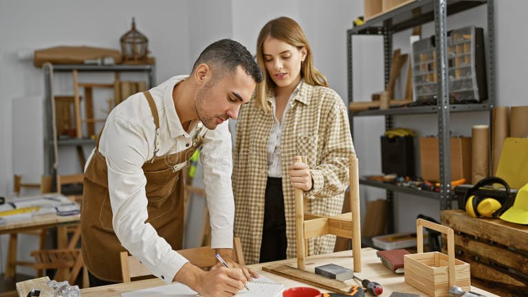 A Man and Woman Collaborate in a Workshop Surrounded by Woodworking ...