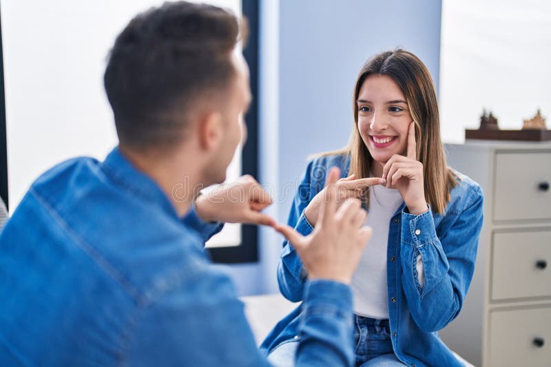 Man and Woman Couple Communicate with Deaf Language Sitting on Sofa at ...