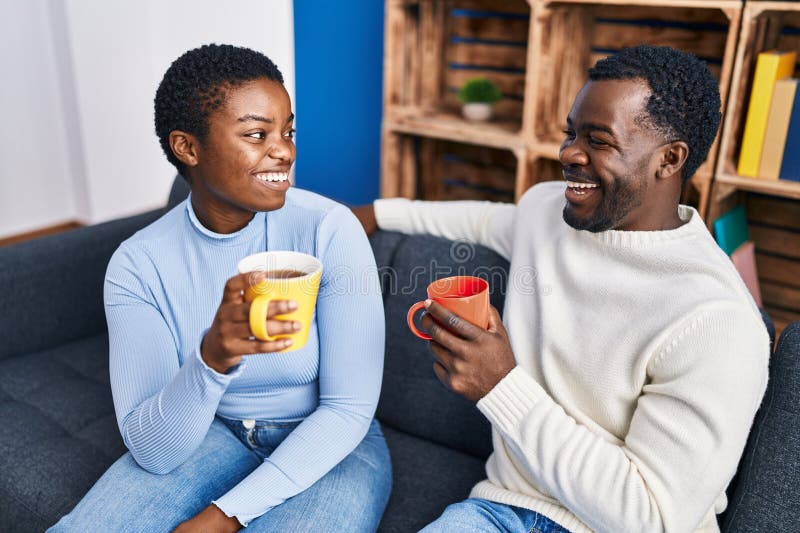 Man and Woman Couple Drinking Coffee Sitting on Sofa at Home Stock ...