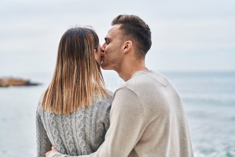 Man And Woman Couple Hugging Each Other On Back View At Seaside Stock