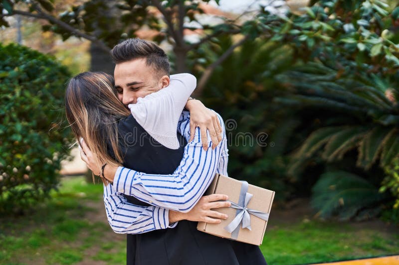 Man And Woman Couple Hugging Each Other Surprise With Birthday T At