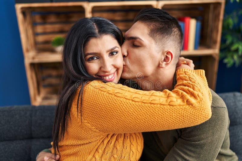 Man And Woman Couple Kissing And Hugging Each Other Sitting On Sofa At