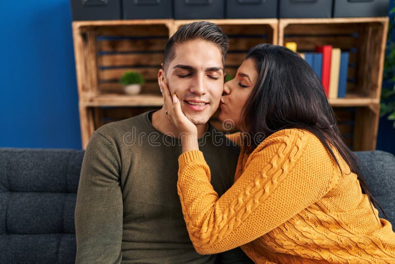 Man And Woman Couple Kissing And Hugging Each Other Sitting On Sofa At