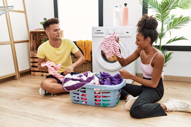 Man and Woman Couple Playing Throwing Clothes at Laundry Room Stock ...