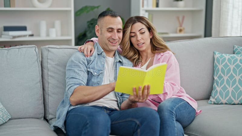 Man and Woman Couple Reading Book Sitting on Sof at Home Stock Video - Video of portrait, female ...