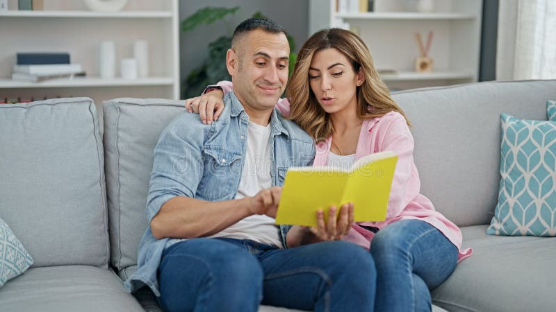 Man and Woman Couple Reading Book Sitting on Sof at Home Stock Image - Image of resting ...