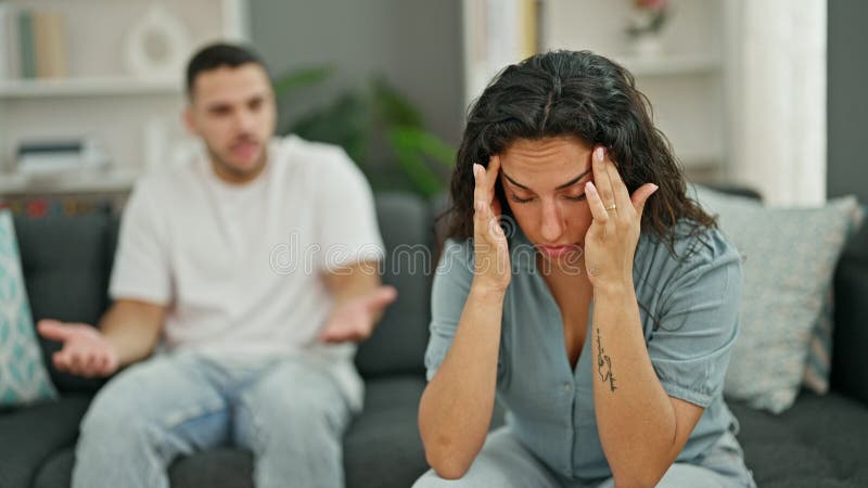 Man And Woman Couple Sitting On Sofa Arguing Stressed At Home Stock