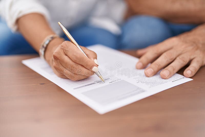 Man and Woman Couple Sitting on Sofa Writing on Document at Home Stock ...