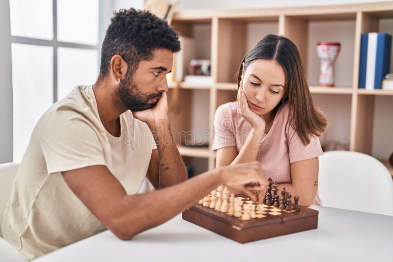 Man and Woman Couple Sitting on Table Playing Chess at Home Stock Photo ...