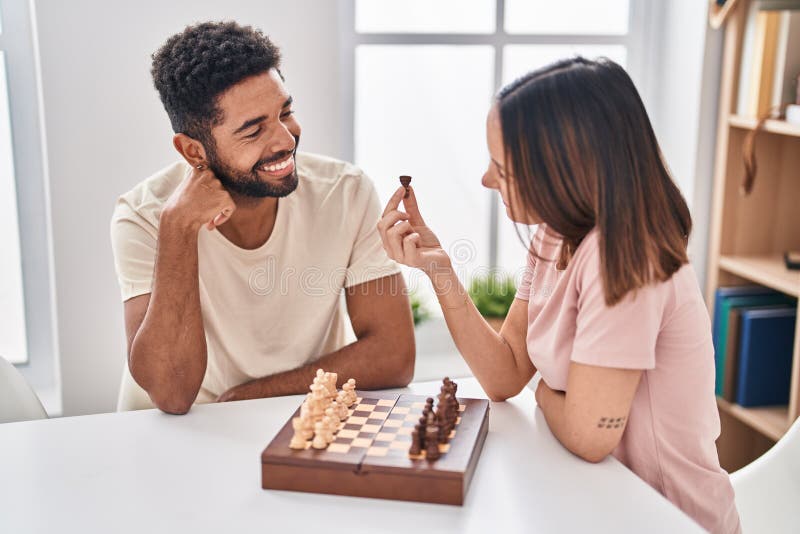 Man and Woman Couple Sitting on Table Playing Chess at Home Stock Photo ...