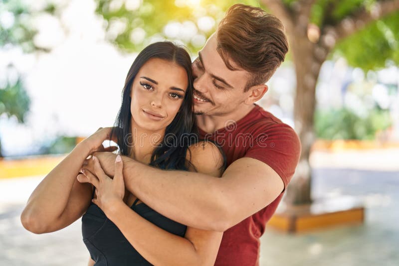 Man And Woman Couple Smiling Confident Hugging Each Other At Park Stock