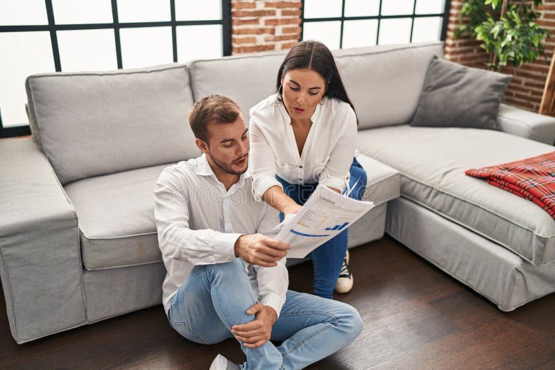 Man and Woman Couple Smiling Confident Reading Document at Home Stock ...