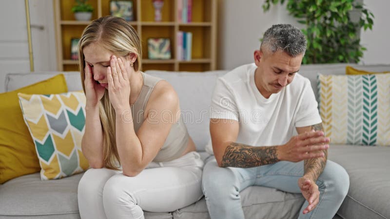 Man And Woman Couple Stressed Sitting On Sofa At Home Stock Footage
