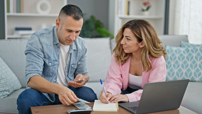 Man and Woman Couple Using Laptop and Taking Notes Counting Peruvian ...