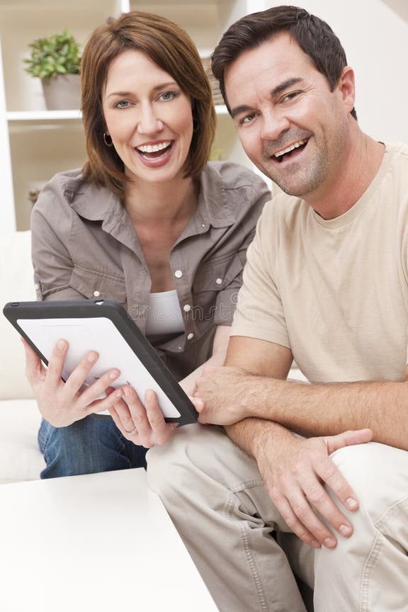 Man & Woman Couple Using Tablet Computer at Home Stock Image - Image of ...