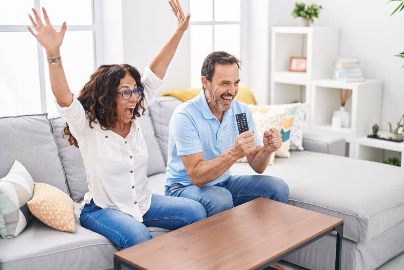 Man and Woman Couple Watching Tv with Winner Expression at Home Stock ...
