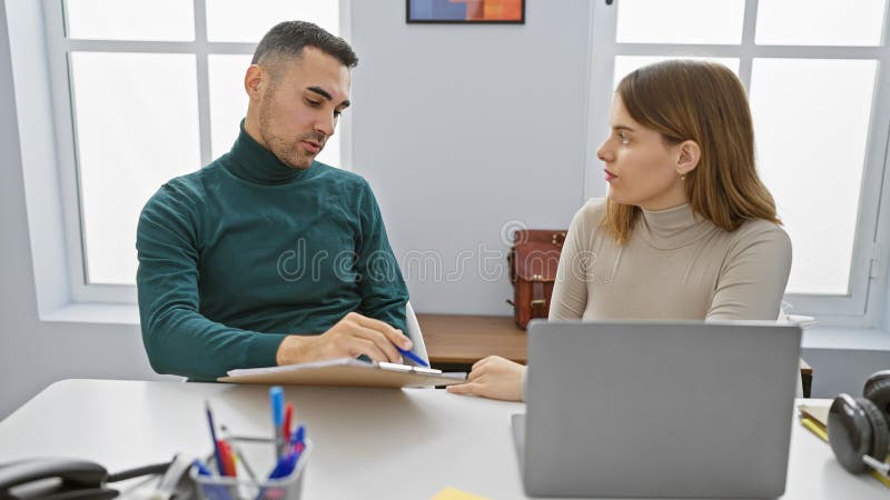 A Man and Woman Coworking in a Bright Modern Office Discuss Over a ...
