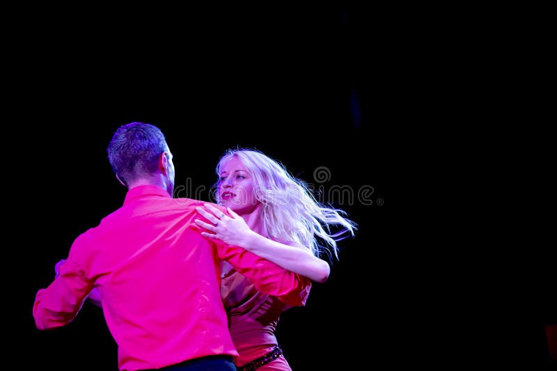 A Man and a Woman are Dancing on a Dark Background Editorial ...