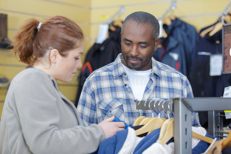 Man and Woman Deciding in Uniform Store Stock Photo - Image of menno ...