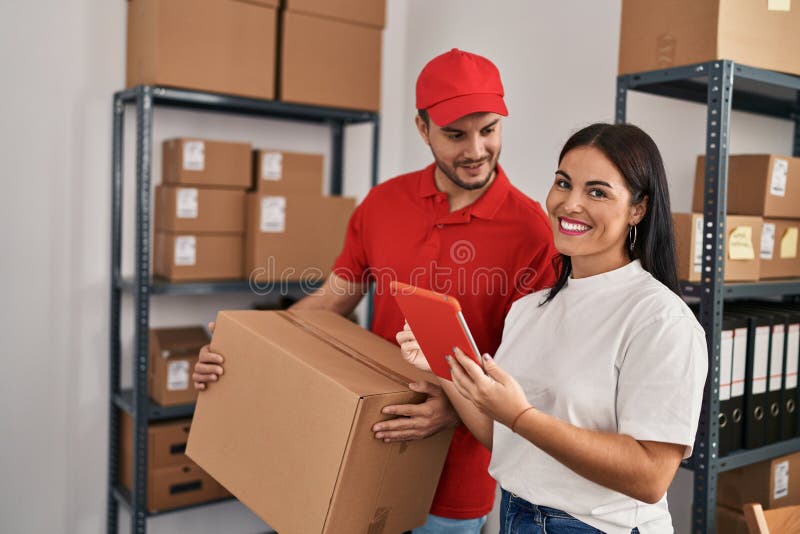 Man and Woman Deliveryman and Worker Holding Package and Using Touchpad ...
