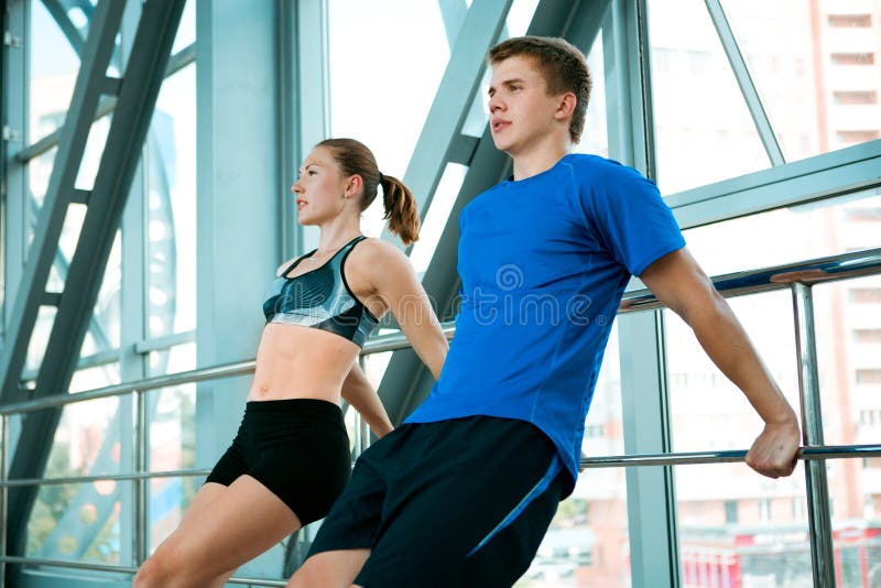 Man And Woman Doing Exercises In The Modern Bridge Construction Stock