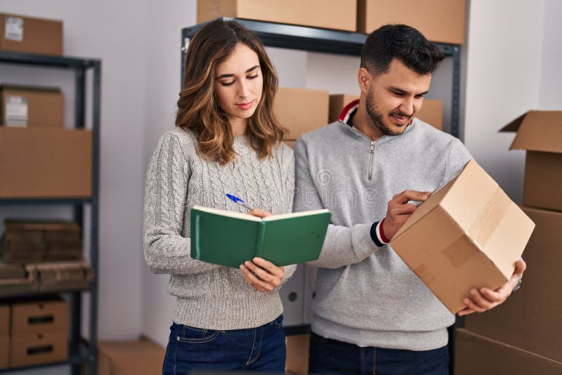 Man and Woman Ecommerce Business Workers Writing on Book Holding ...