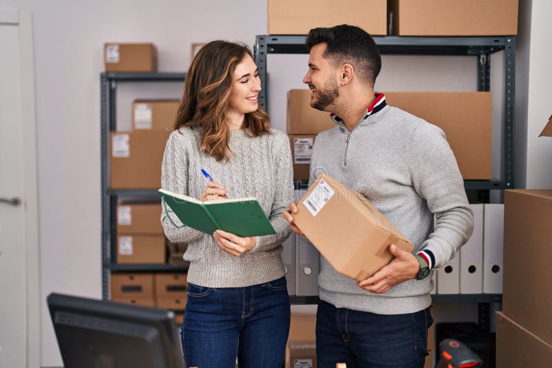 Man and Woman Ecommerce Business Workers Writing on Book Holding ...