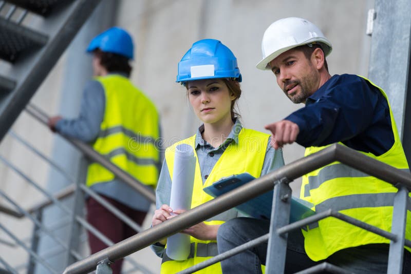 Man and Woman Engineer Talking in Hardhats Stock Image - Image of ...