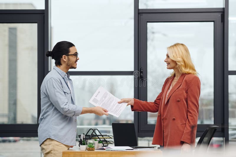 A Man and Woman Exchanging Documents Stock Photo - Image of meeting ...