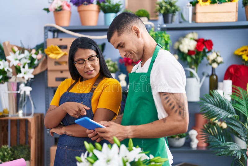 Man and Woman Florists Smiling Confident Using Touchpad at Florist ...
