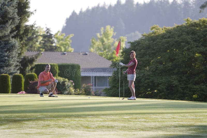 Man and Woman on Golf Course - Horizontal Stock Image - Image of chip ...