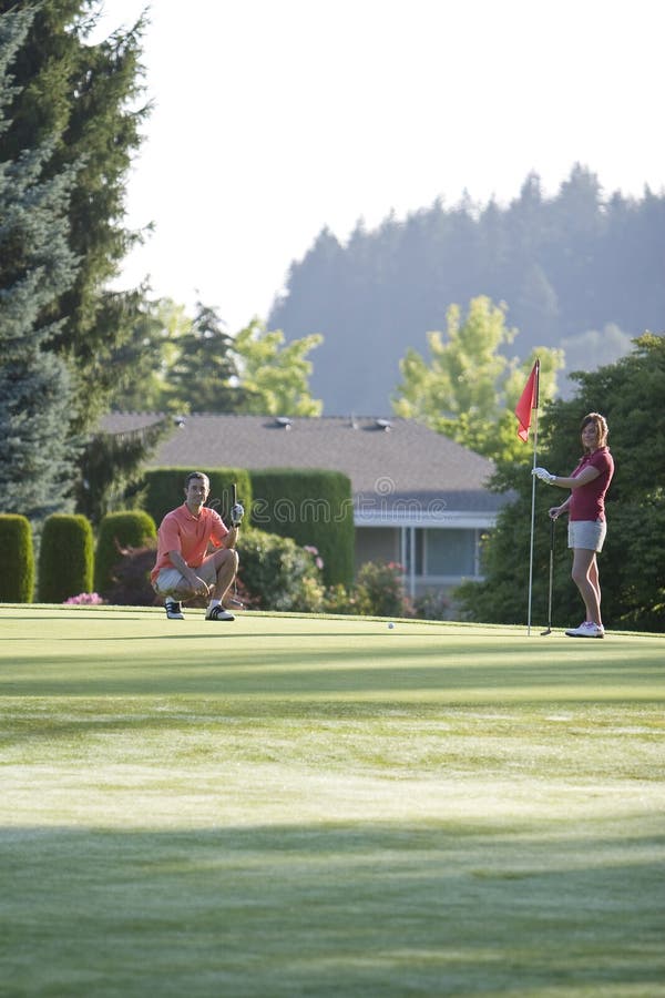Man And Woman On Golf Course - Vertical Picture. Image: 5985516