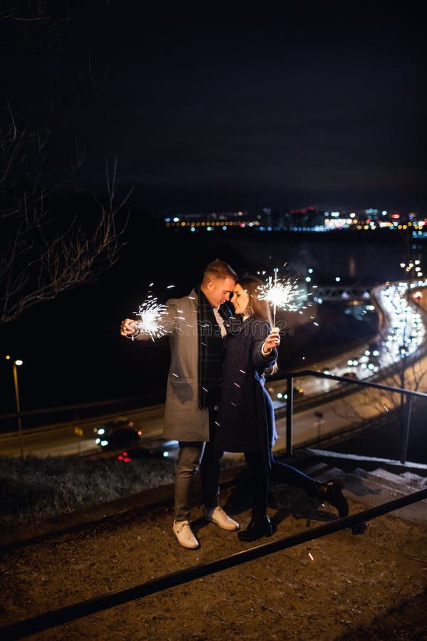 Man and Woman Holding a Burning Sparkler. Bengal Fire Stock Photo ...