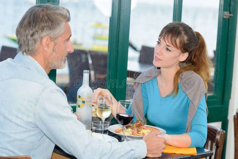 Couple Holding Hands Across Table Vertical Stock Photos - Free ...