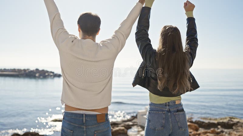 A Man and Woman Holding Hands Raised in Celebration Against a Sparkling ...
