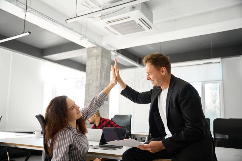 Man and Woman Interchanging High Five after Successful Work Plan ...