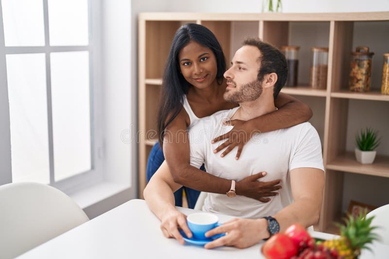 Man And Woman Interracial Couple Drinking Coffee Sitting On Table At