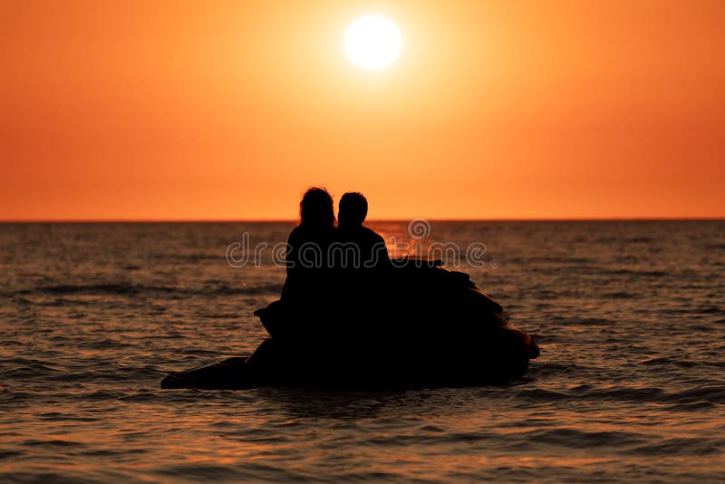 Man Woman on a Jet Scooter on the Sea at Sunset Stock Photo - Image of ...