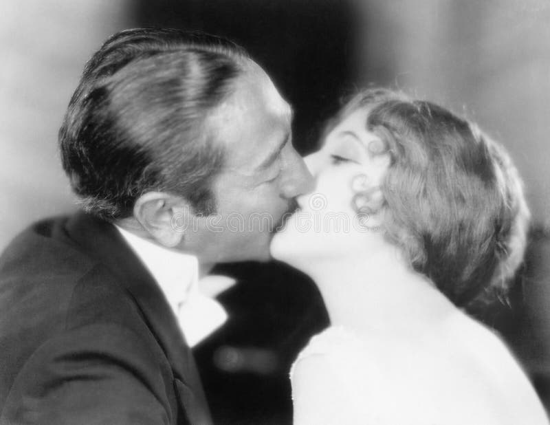 Man and Woman Kissing Each Other Stock Image - Image of black, inside ...