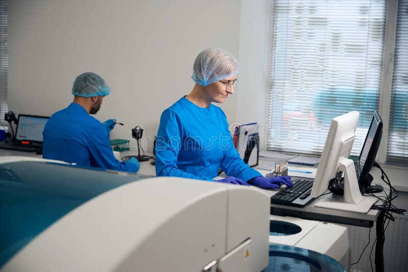Man and Woman Laboratory Assistants Use Modern Computers at Work Stock ...