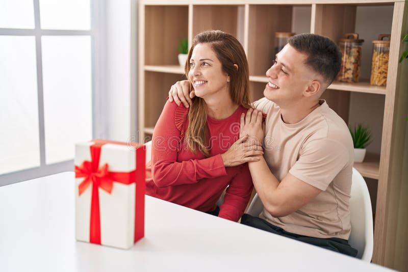 Man and Woman Mother and Son Sitting on Table with Gift at Home Stock ...