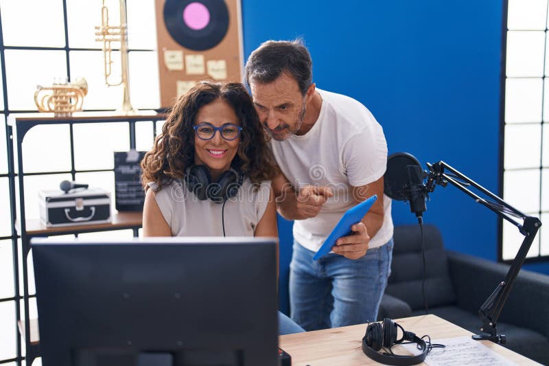 Man and Woman Musicians Composing Song Using Computer and Touchpad at ...