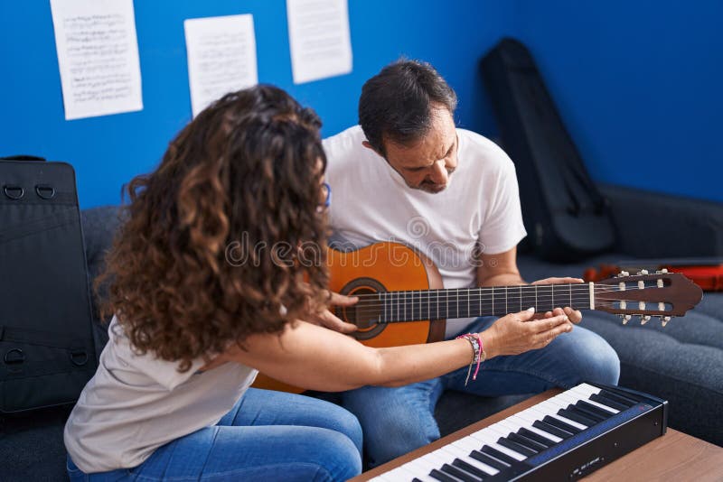 Man and Woman Musicians Having Classical Guitar Lesson at Music Studio ...