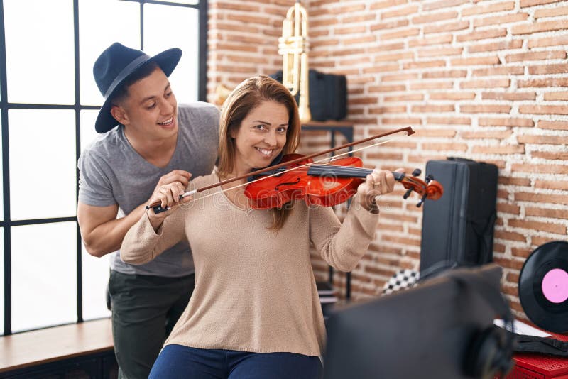 Man and Woman Musicians Playing Violin at Music Studio Stock Image ...