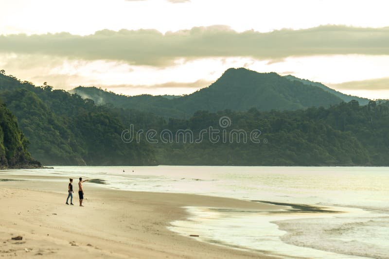 Man and Woman are Overlooking the Shores of the Ocean. Stock Image ...