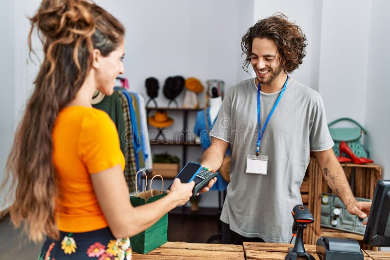 Man and Woman Paying Purchase Using Smartphone and Data Phone at ...