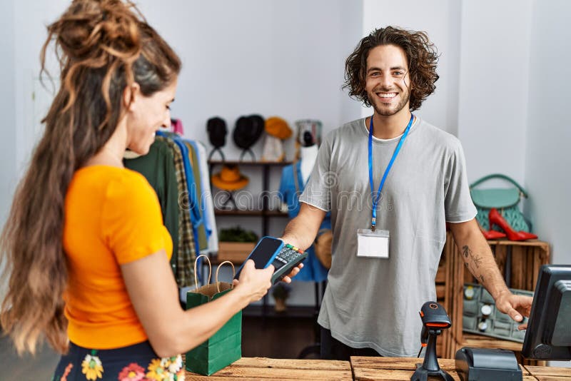 Man and Woman Paying Purchase Using Smartphone and Data Phone at ...