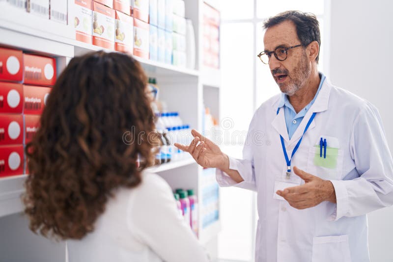 Man and Woman Pharmacist and Customer Speaking at Pharmacy Stock Image ...