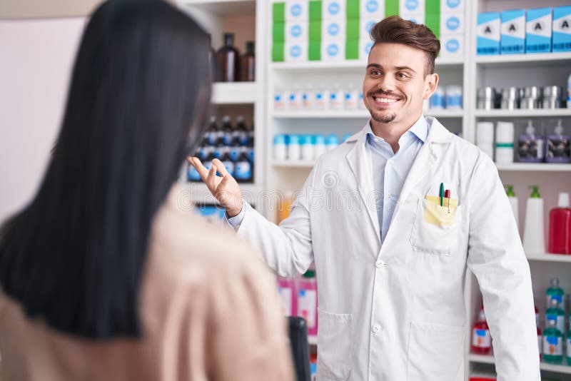 Man and Woman Pharmacist Speaking To Client at Pharmacy Stock Image ...